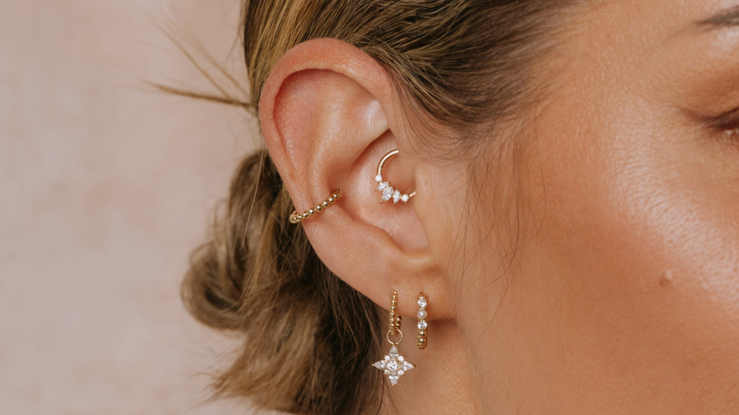 Laura Bond - solid gold huggies, helix, tragus, conch & daith earrings